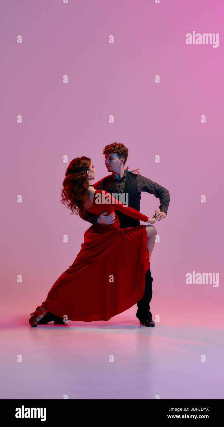 Argentine tango dancers striking dramatic pose under pink and purple ...
