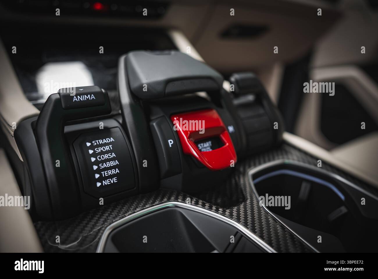 Detailed view of the Lamborghini Urus center console featuring a red engine start button ...