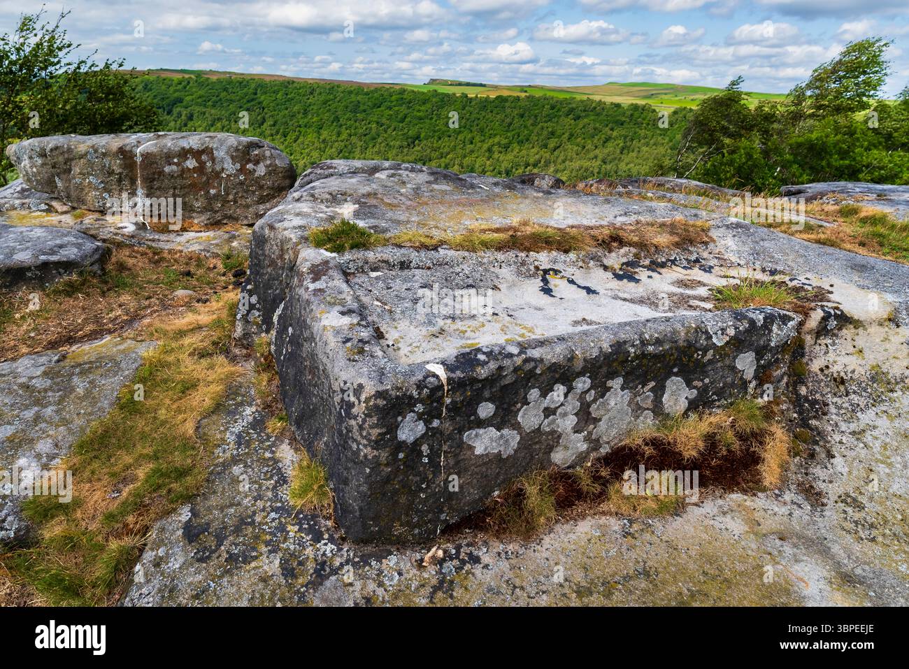 Unfinished and abandoned stone water trough, carved from a single ...