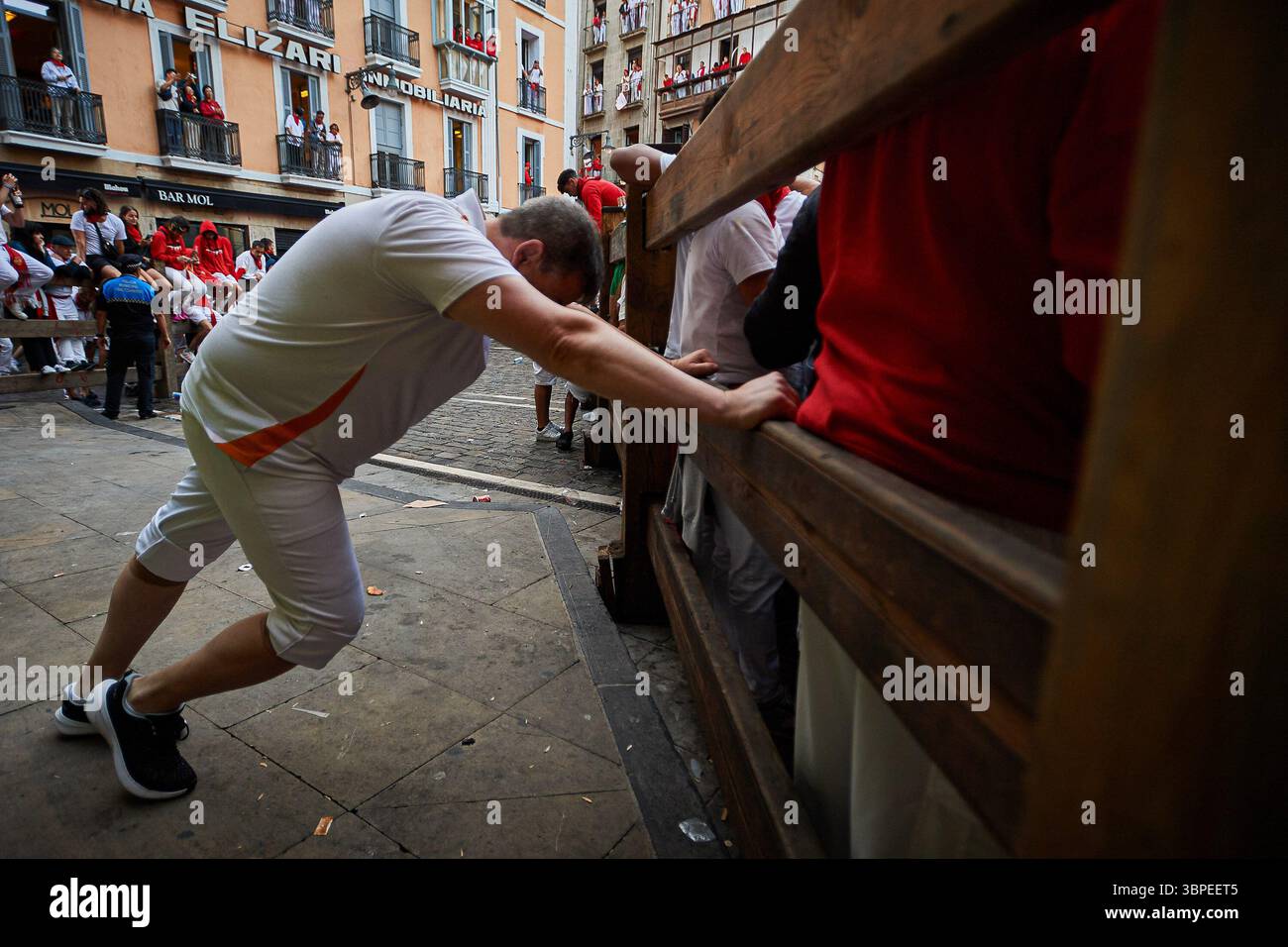 Juan Pedro Lecuona, a seasoned bull runner stretches his muscles before ...