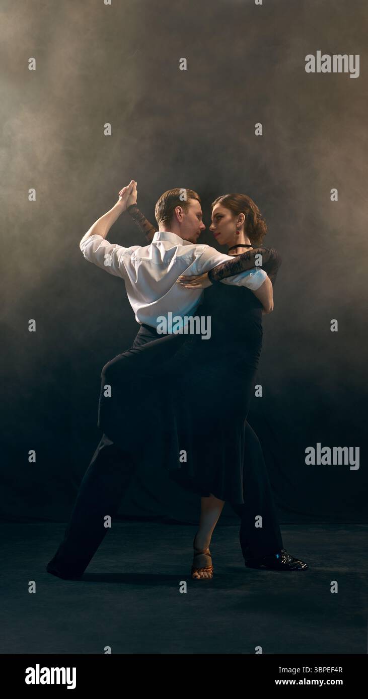 Elegant dancers striking passionate pose performing Argentine tango ...