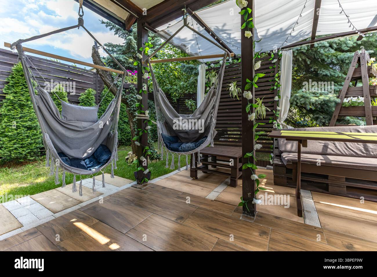 Rocking hammock, gray Brazilian chair hanging on the porch under a ...