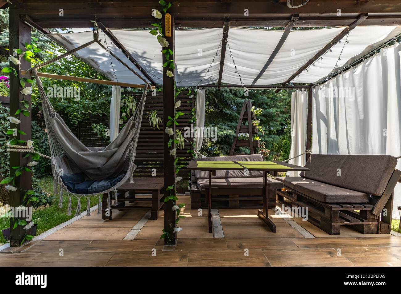 Rocking hammock, gray Brazilian chair hanging on the porch under a ...