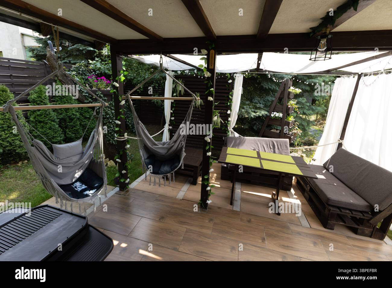 Rocking hammock, gray Brazilian chair hanging on the porch under a ...