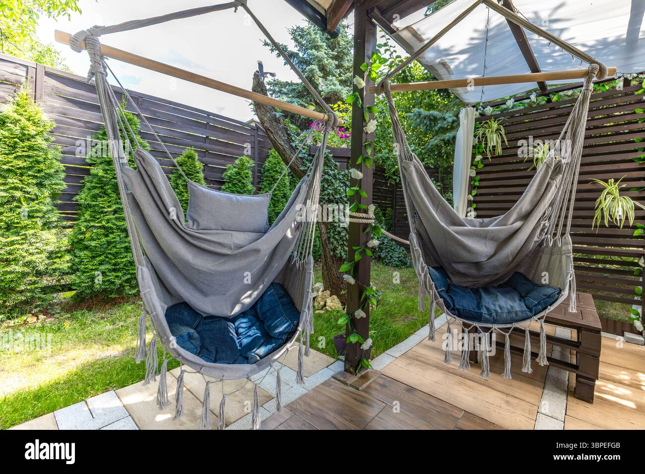 Rocking hammock, gray Brazilian chair hanging on the porch under a ...