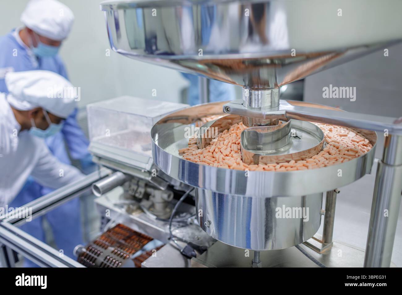 Automated tablet production line in a cleanroom facility with staff in ...
