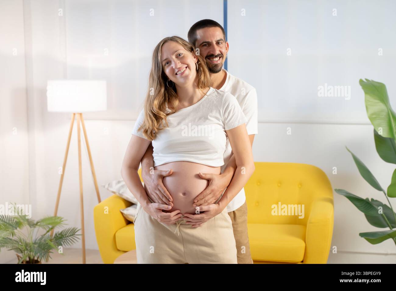 Pregnancy couple portrait smiling happy touching belly Stock Photo - Alamy