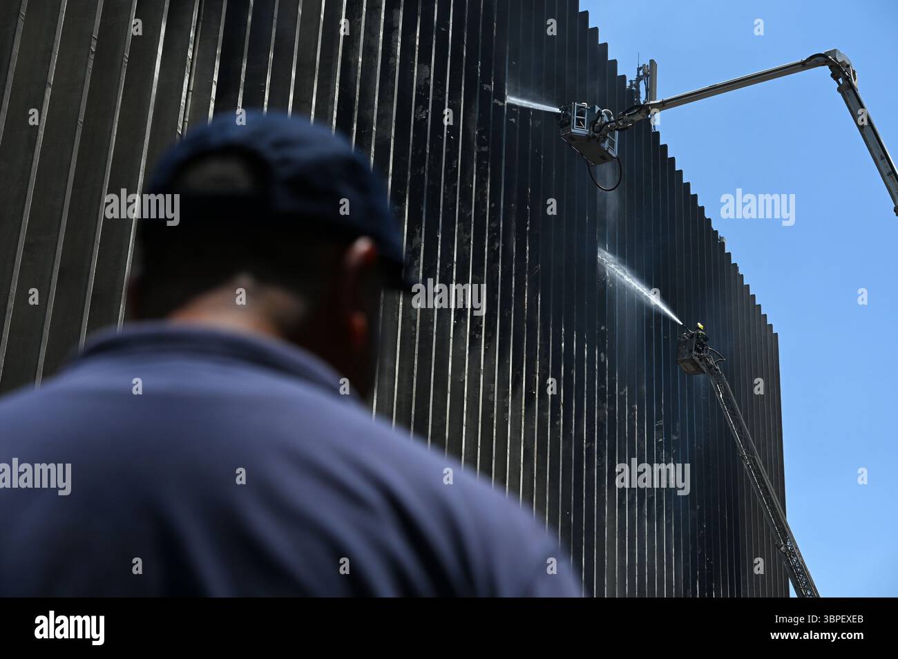 Cairo, Egypt. 08th July, 2025. A firefighter works to extinguish a fire ...