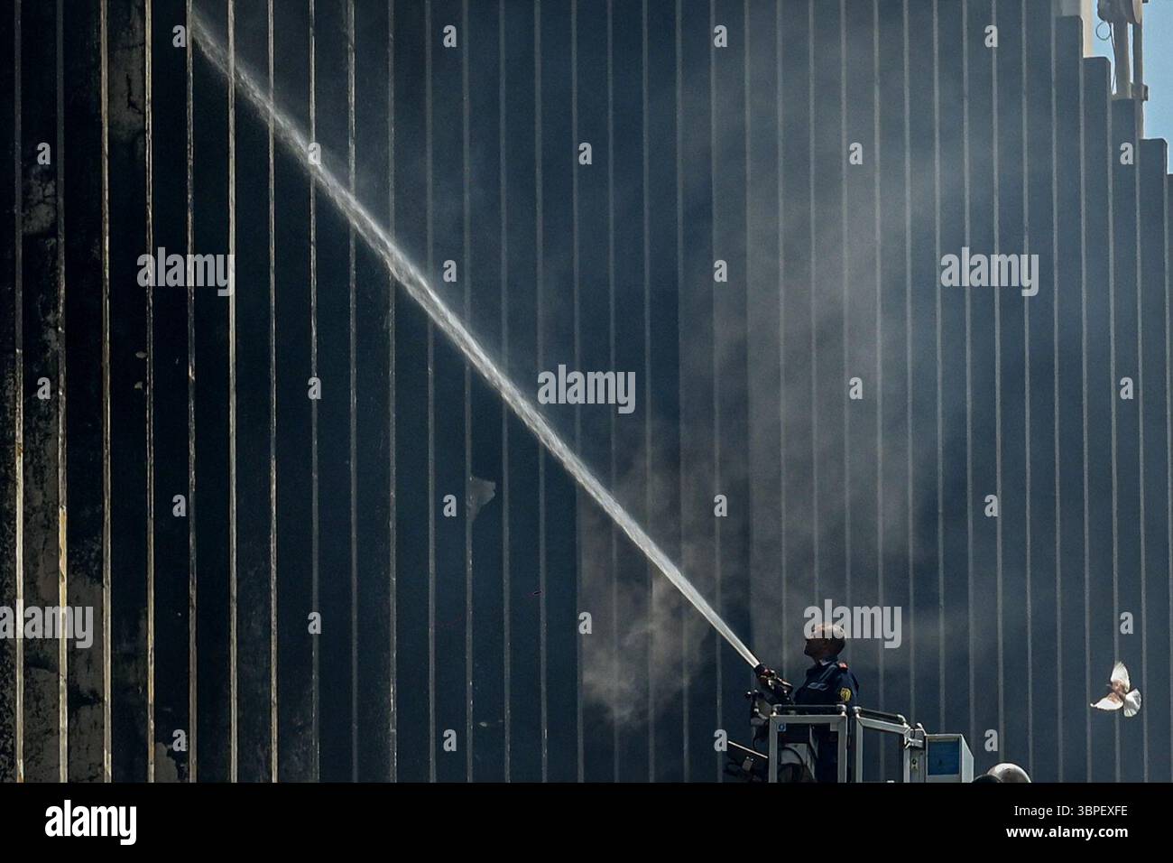 Cairo, Egypt. 08th July, 2025. A firefighter works to extinguish a fire ...