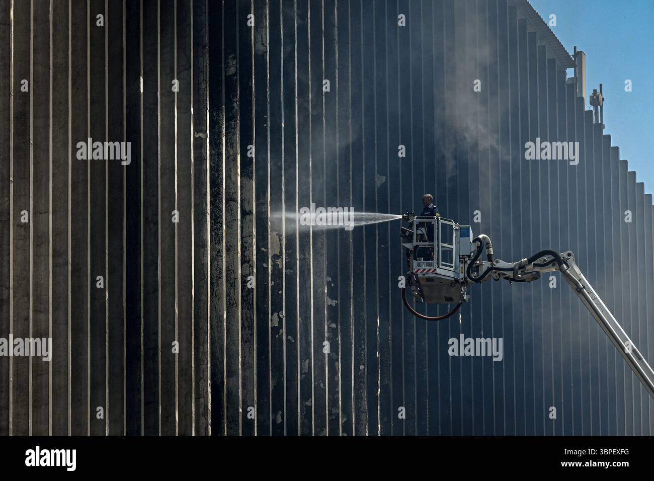 08 July 2025, Egypt, Cairo: A firefighter works to extinguish a fire at ...