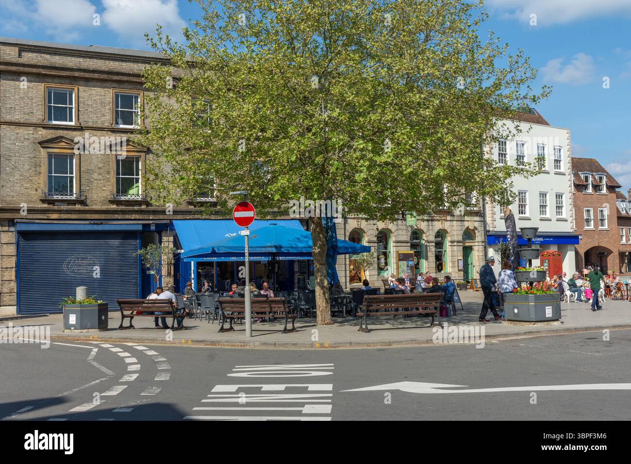 The Square, Wimborne Minster, UK - April 27th 2025: People sitting ...