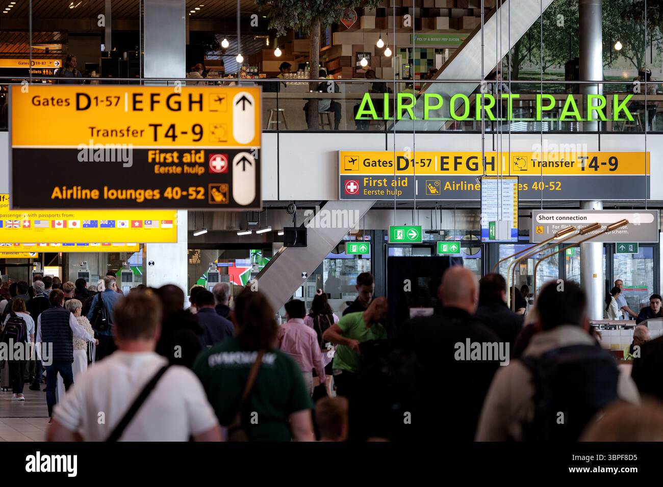 SCHIPHOL - Passengers walk toward their gate in Lounge 1, the shopping ...