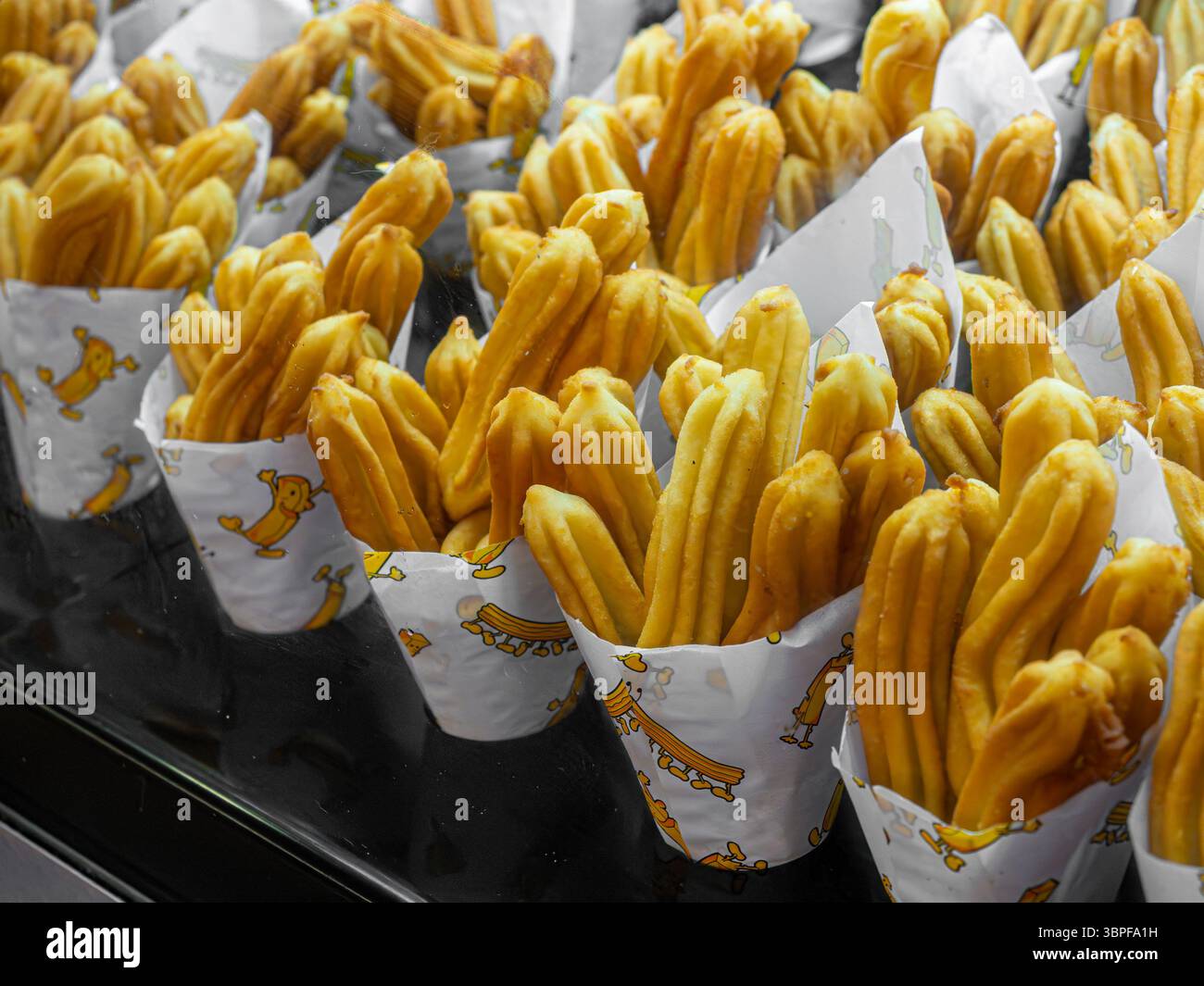 Paper cones of freshly fried churros, a traditional Spanish and Catalan ...