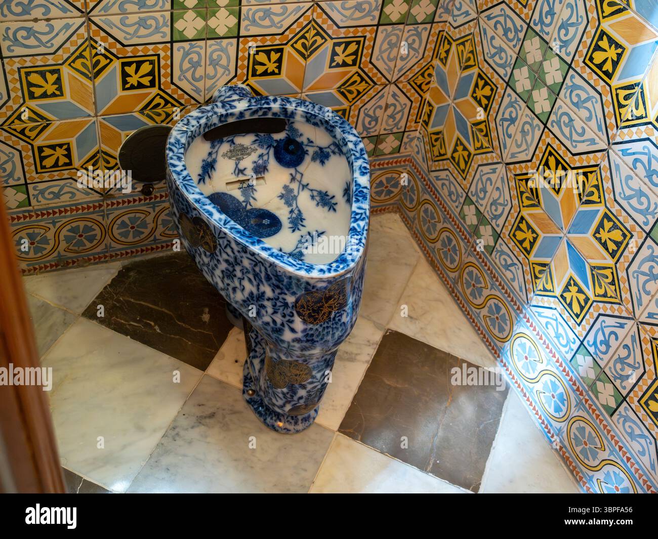 An ornate, historic toilet with blue and white floral patterns and ...