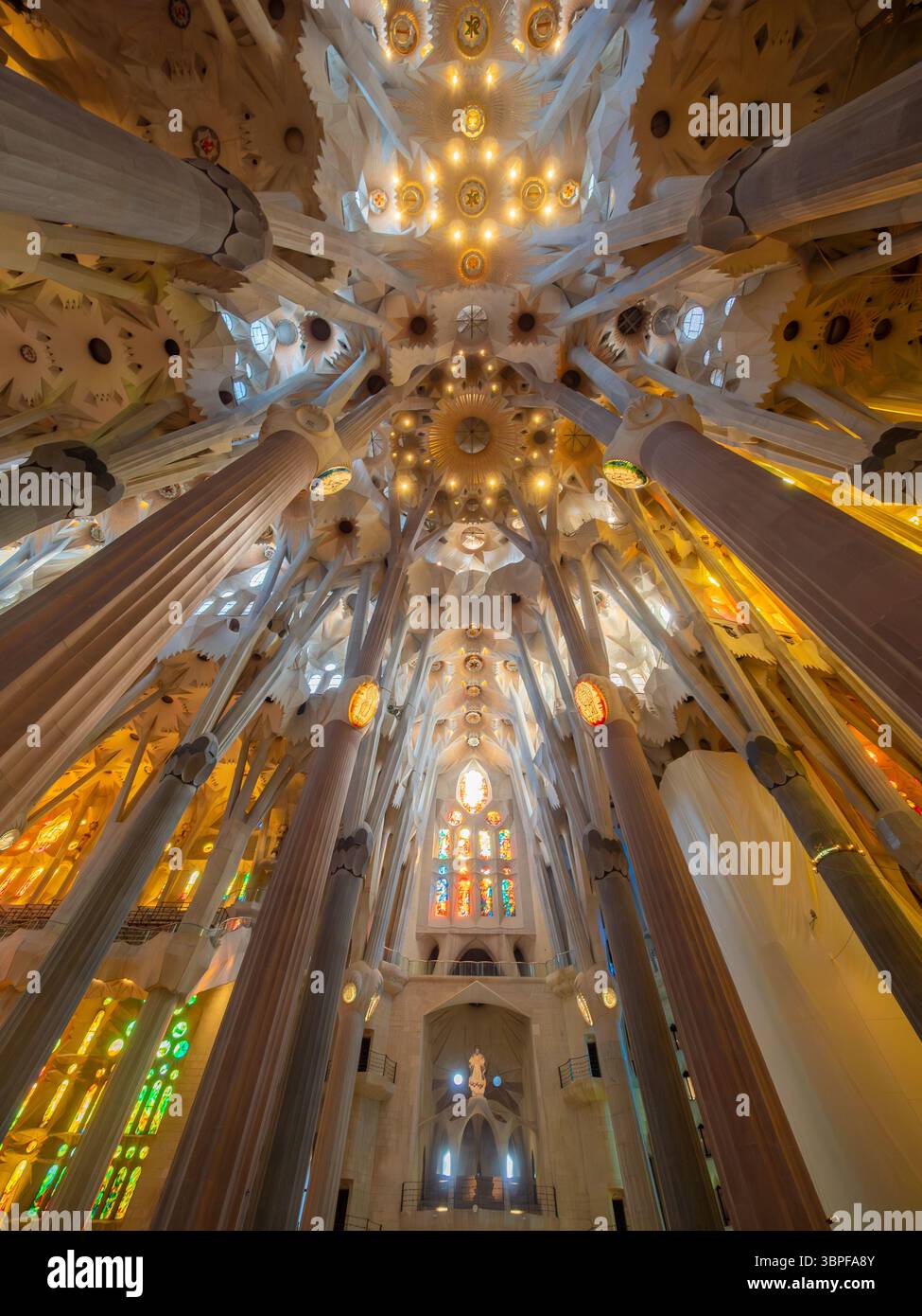 A vertical panorama looking up at the vaulted ceiling of Antoni Gaudí's ...