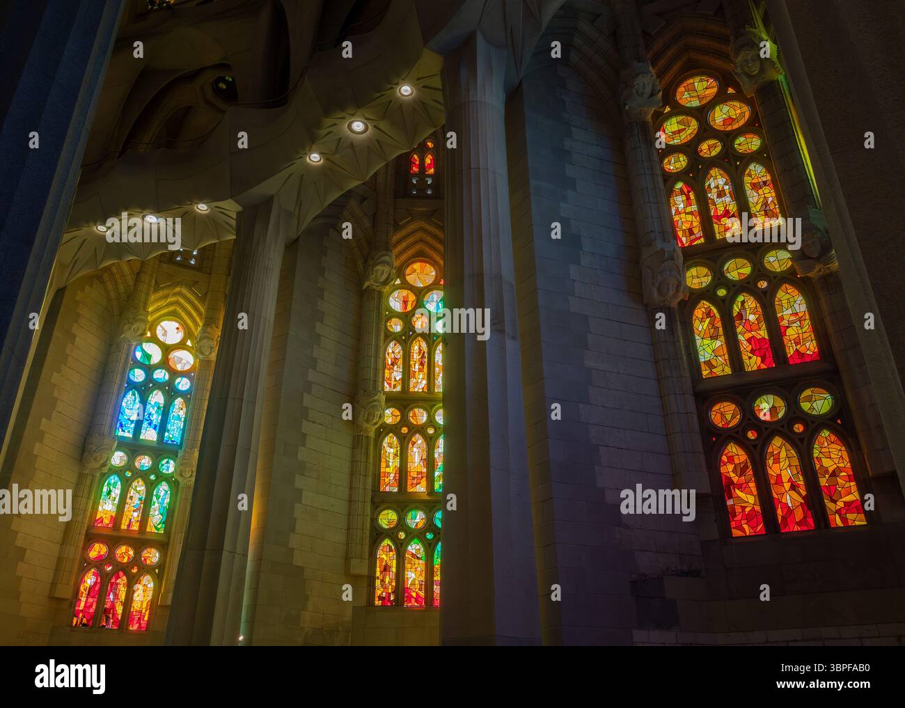 Interior view of colourful stained glass windows of the Passion facade ...