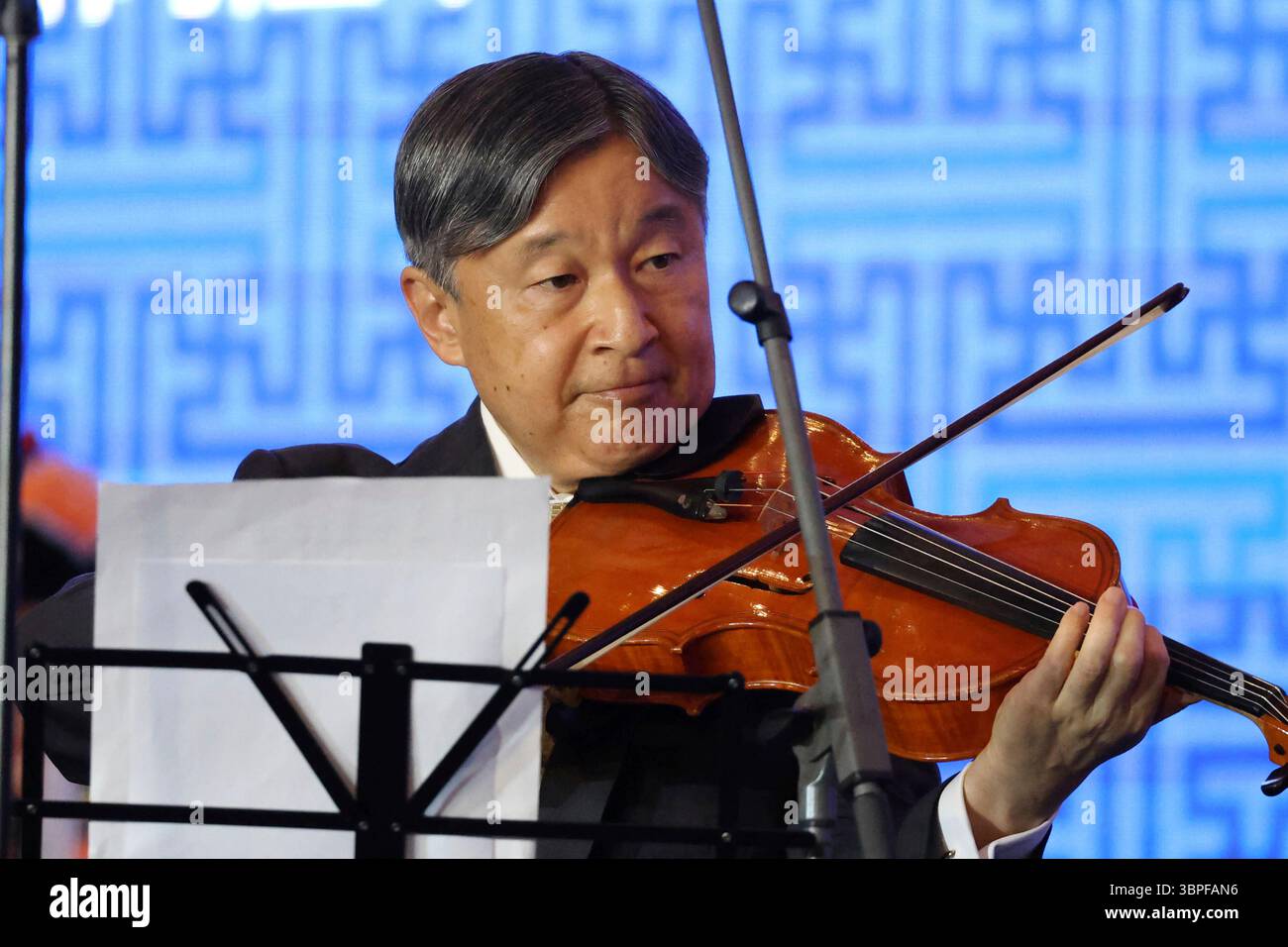 Japan's Emperor Naruhito plays the viola during an official banquet ...