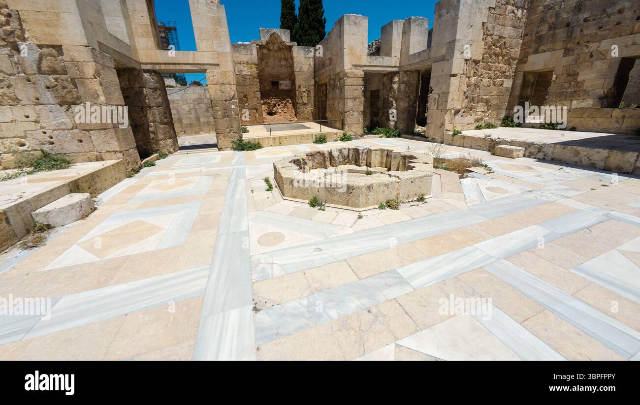 Ancient stone courtyard with a central octagonal fountain, surrounded ...