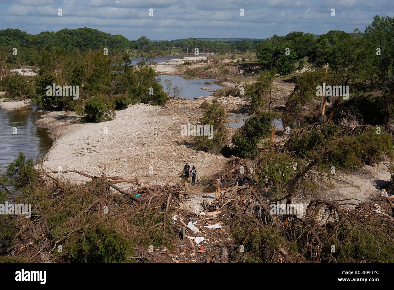 Search and rescue teams from Kerrville Fire Department walk past debris ...