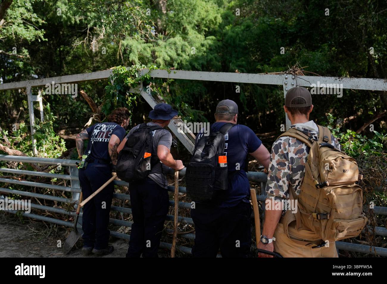 Search and rescue teams from Kerrville Fire Department search look over ...