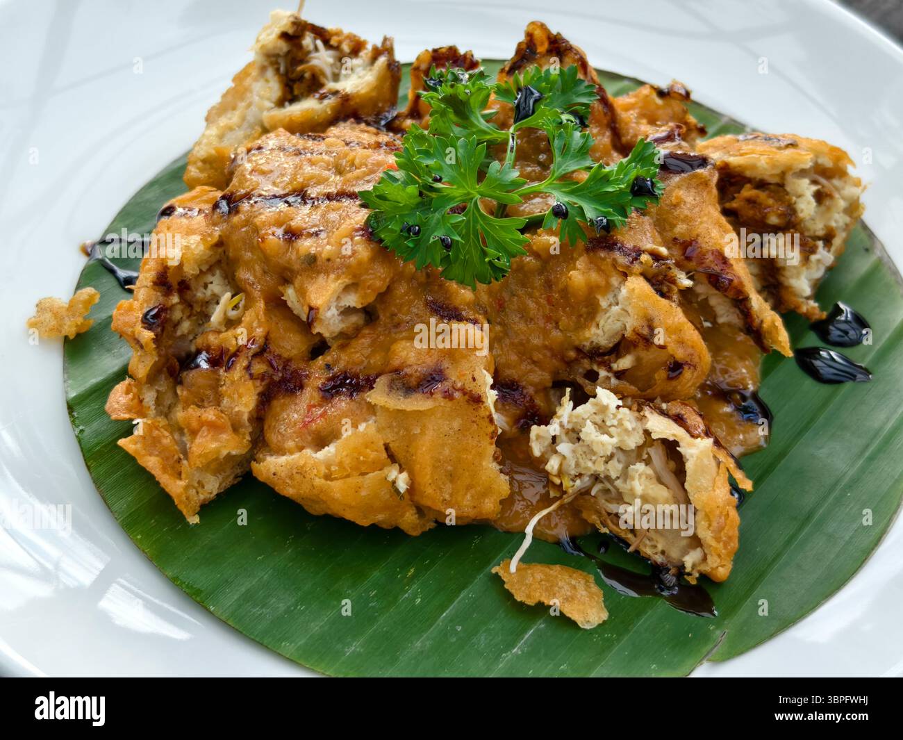 A plate of deep-fried crispy tofu stuffed filled with vegetables and ...