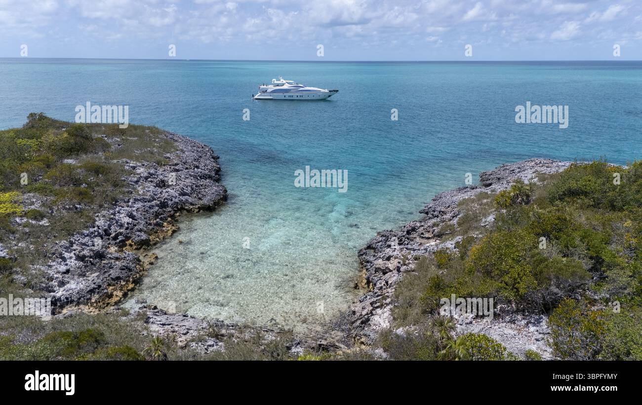 Aerial view of turquoise waters meet rugged coastlines and a luxurious ...