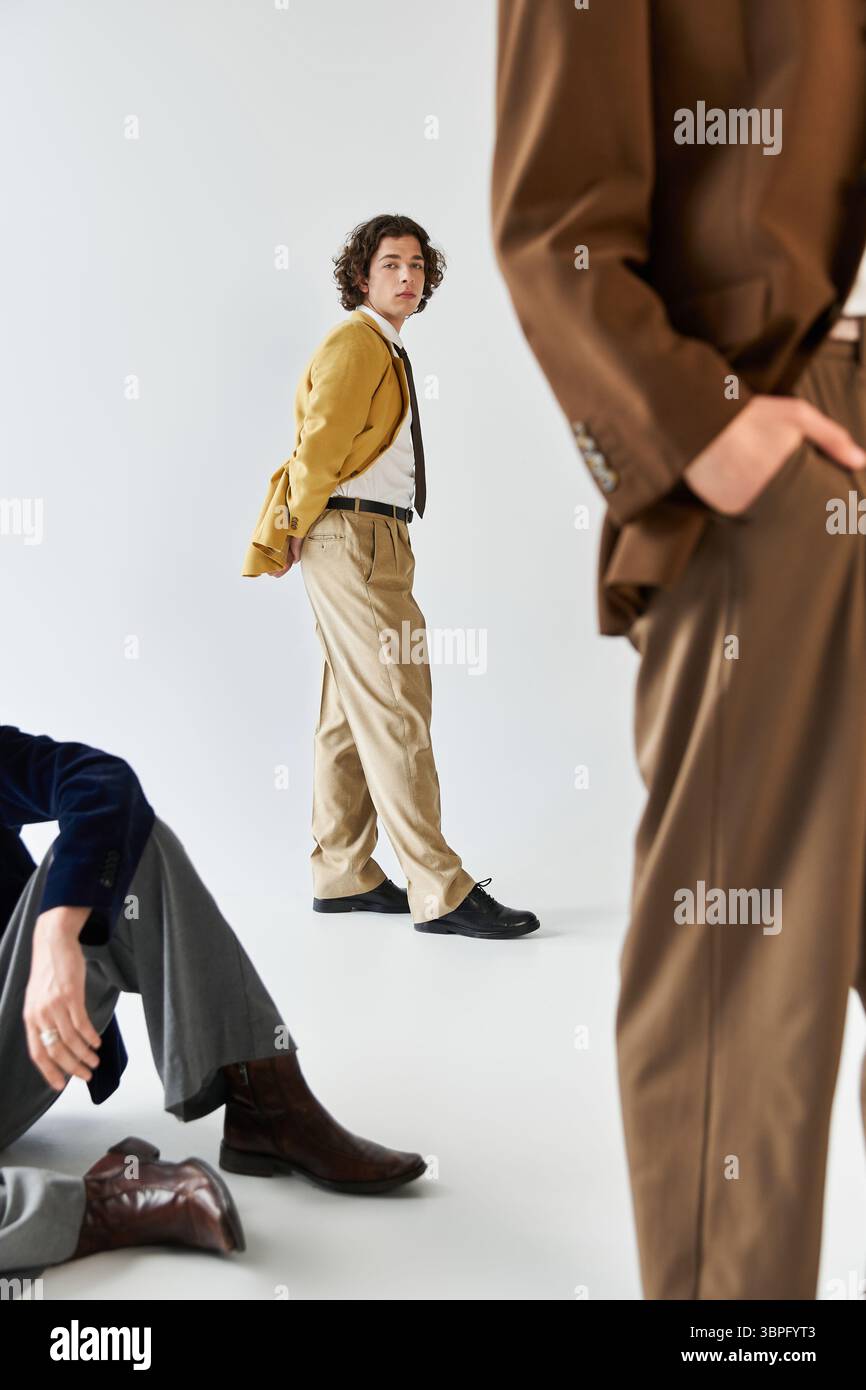 Fashion forward young men pose together, displaying their unique styles ...
