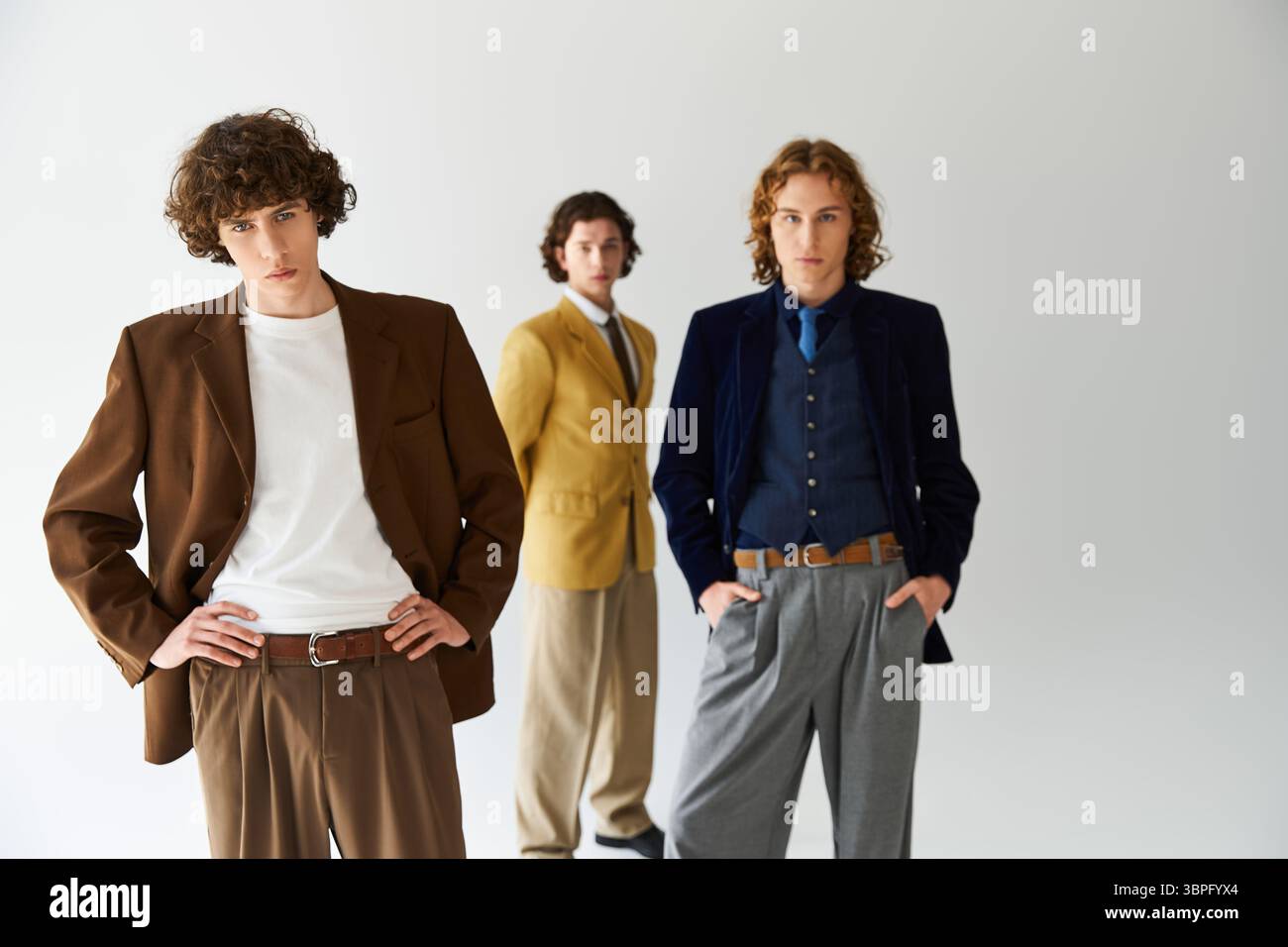 Three stylishly dressed young men stand together, each with unique ...