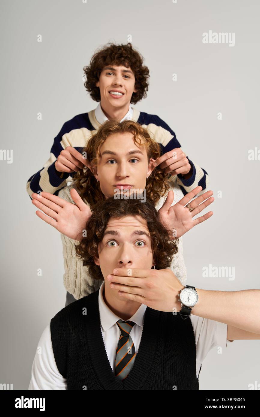 Three trendy men express their individuality through playful poses and ...