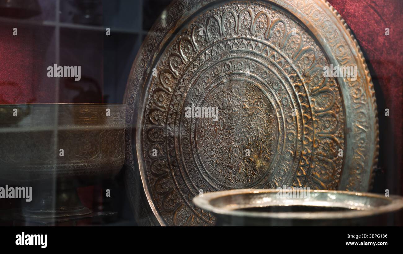 Visitors explore the Hilla Museum in Iraq, admiring ancient silver ...