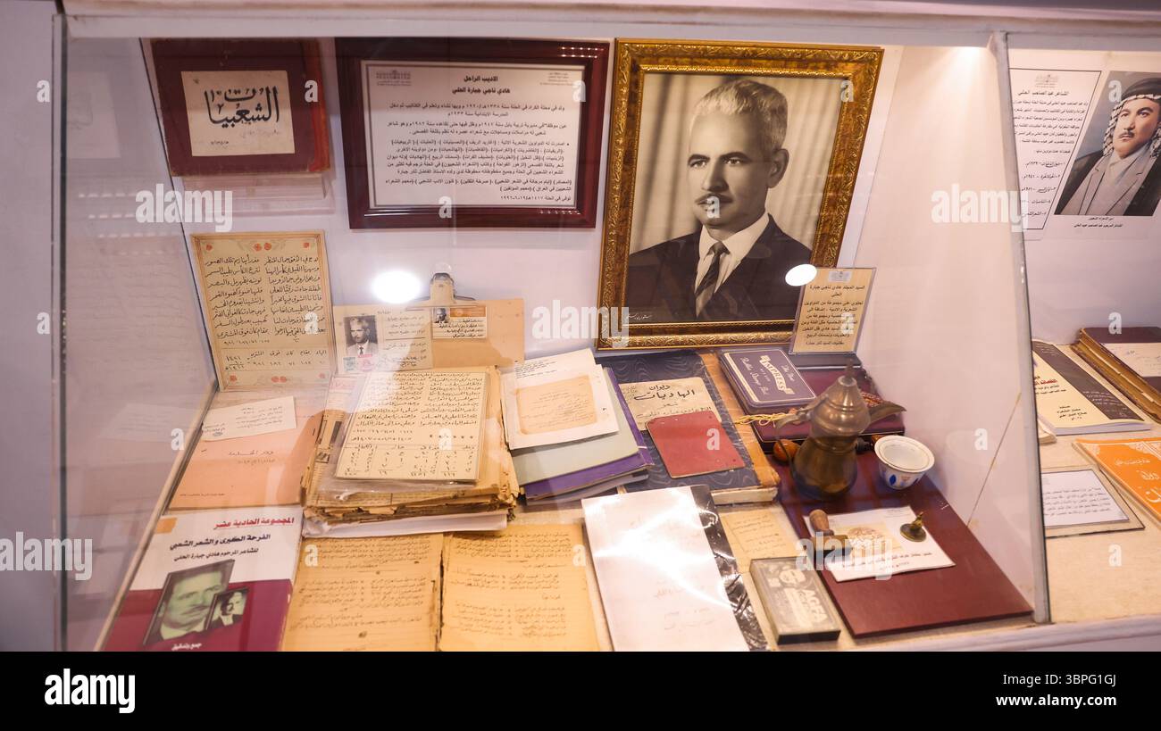 Artifacts on exhibit include books, documents, and a framed portrait ...