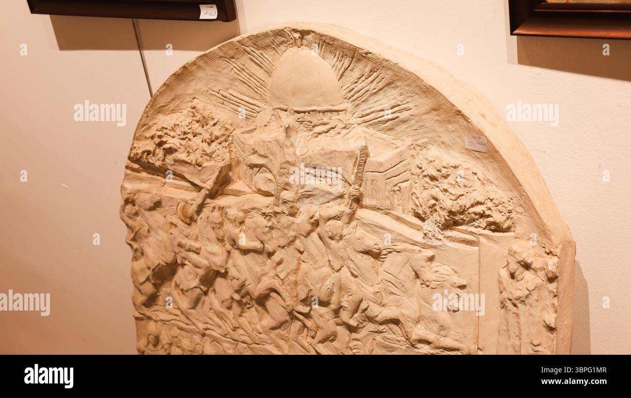 Visitors explore a detailed relief sculpture showcasing significant ...