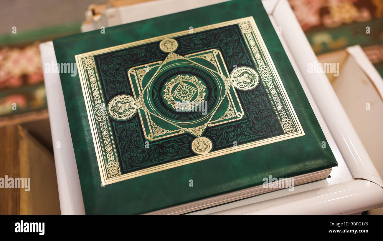 Intricate manuscript with a green cover is prominently featured in ...