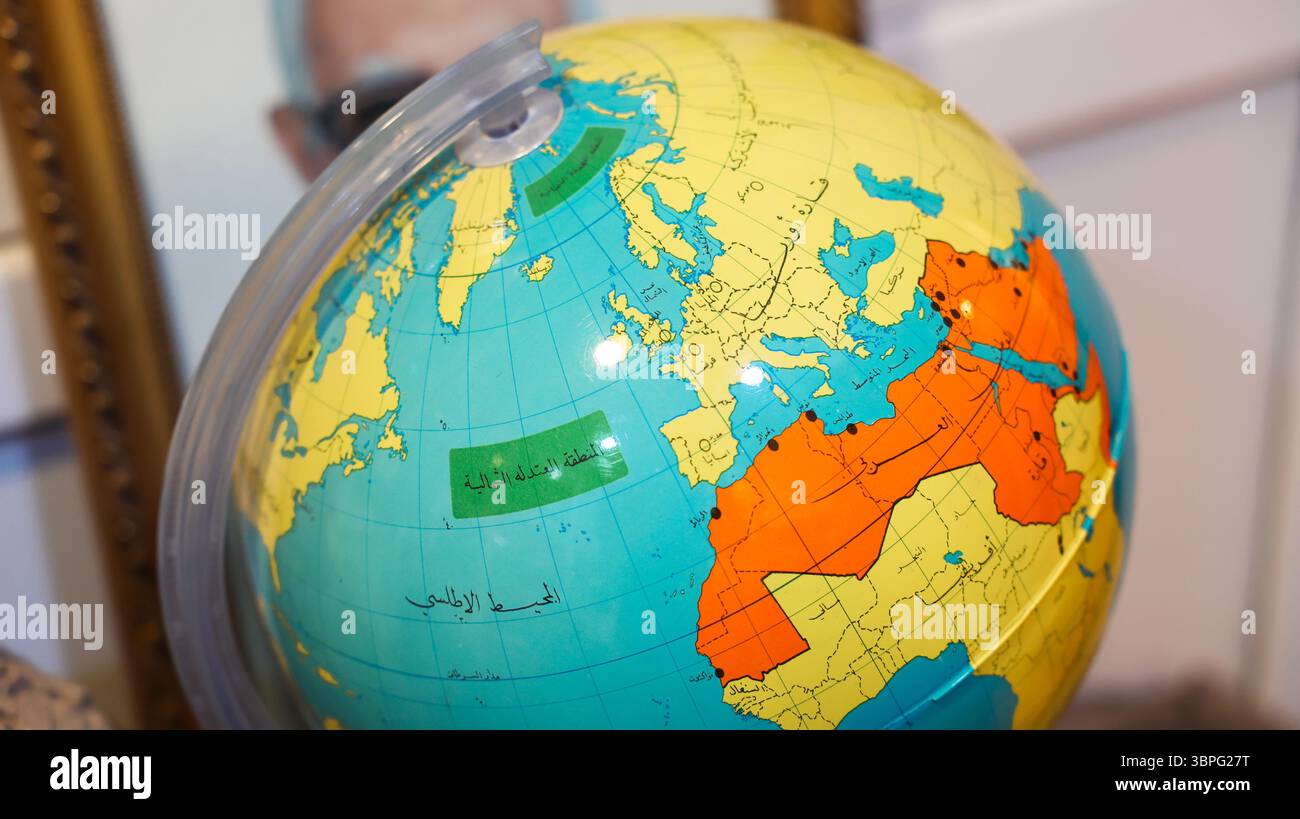 Visitors at Hilla Museum explore an interactive globe exhibit ...