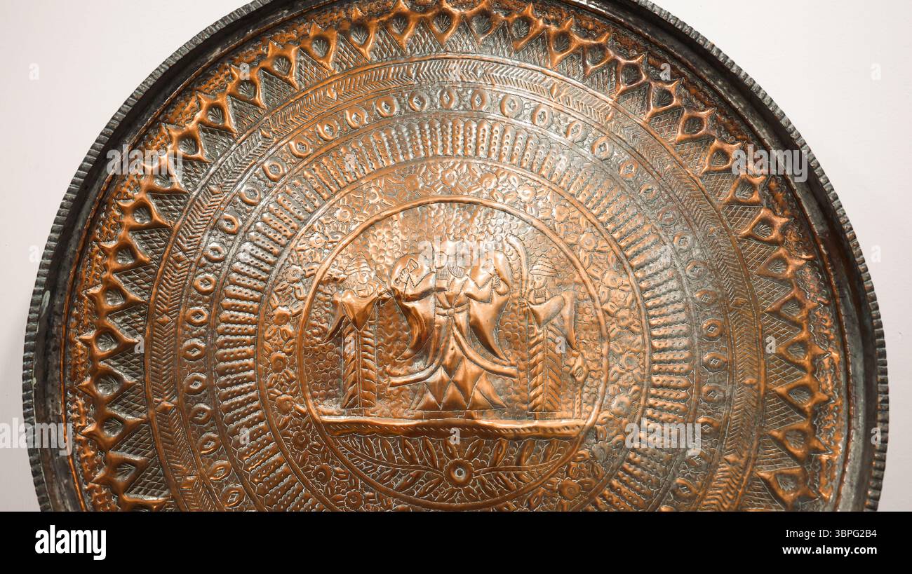 An ancient decorative plate displays detailed craftsmanship ...