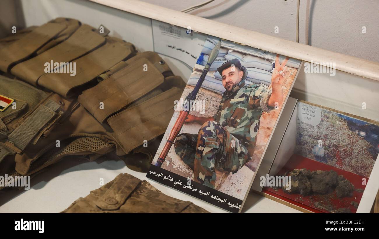 A tribute to a soldier displayed with military gear and memorabilia at ...