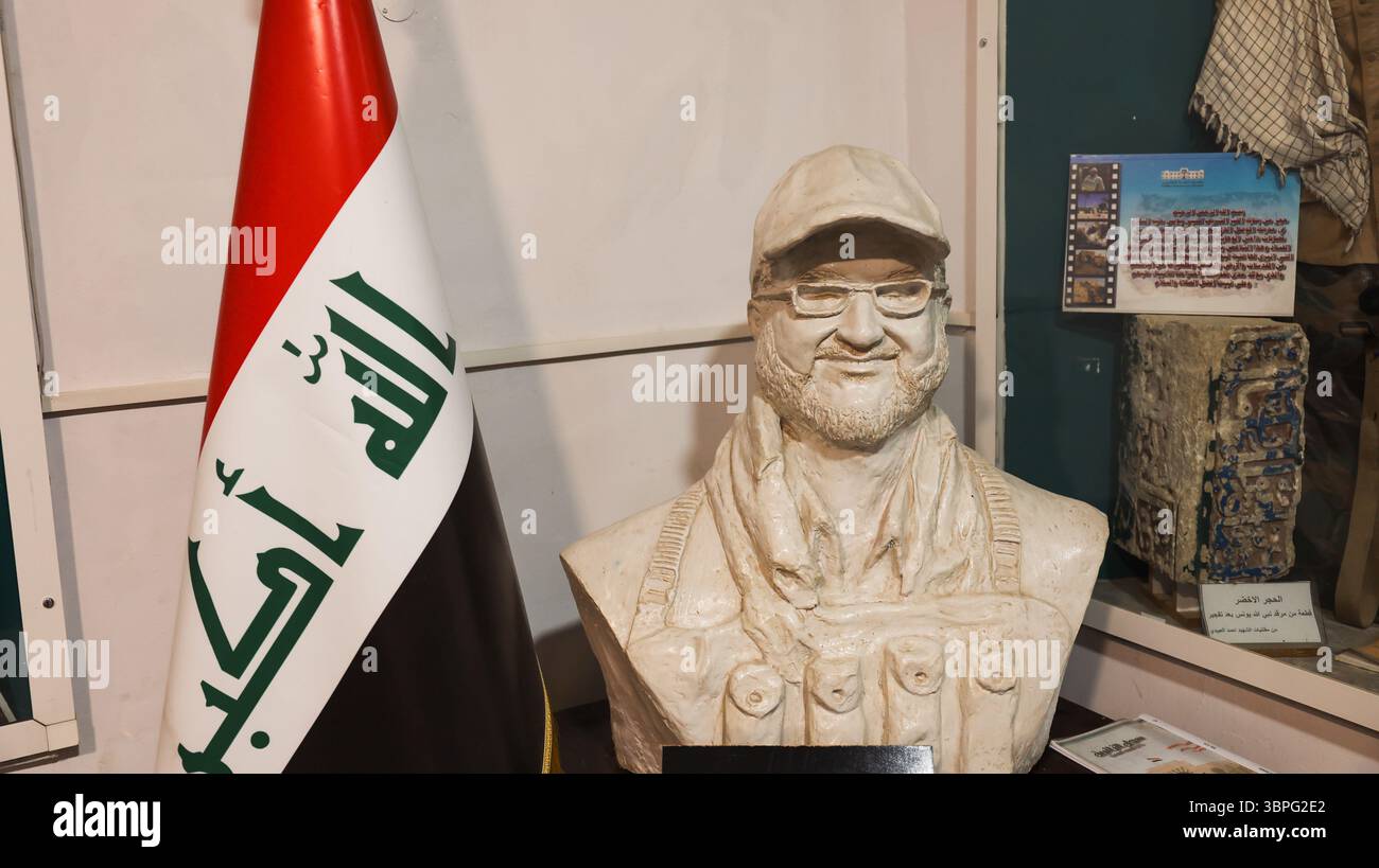 Bust of a local figure displayed alongside an Iraqi flag in Hilla ...
