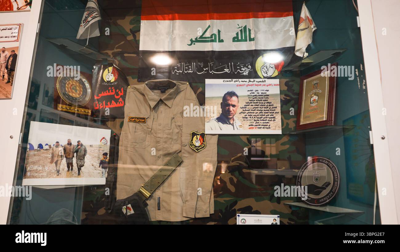 Military uniforms, photographs, and flags are showcased in an exhibit ...