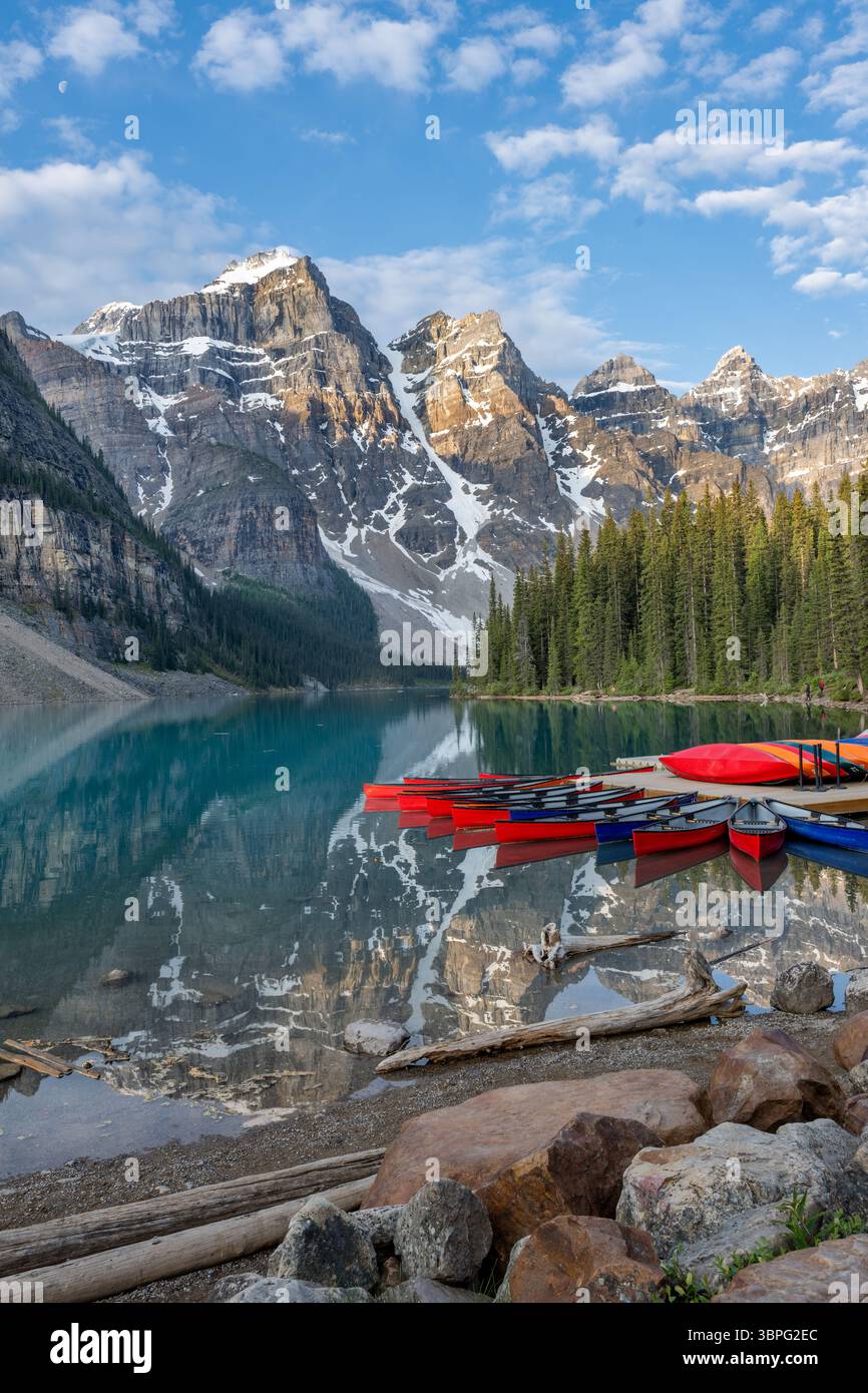 Moraine Lake with canoes & mountains reflection in the lake, Banff National Park, Alberta ...
