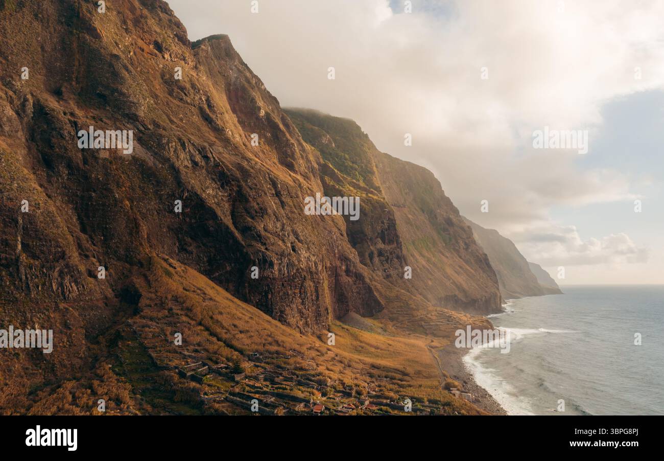 Aerial view of steep cliffs cascading into the ocean, where the land ...