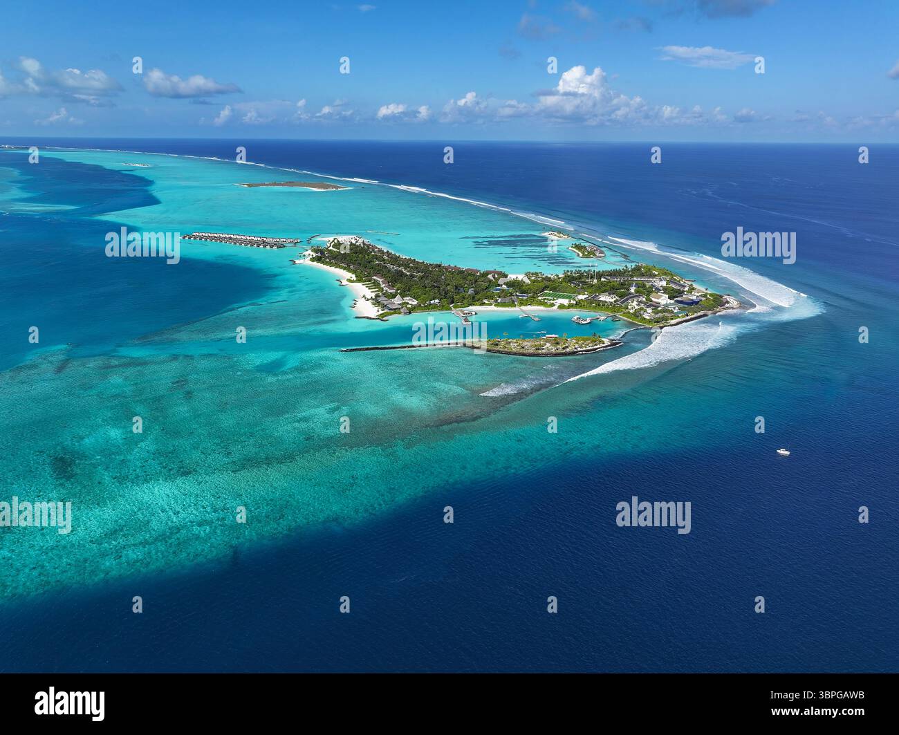 Aerial view of the resort's turquoise lagoon gently embrace the white ...