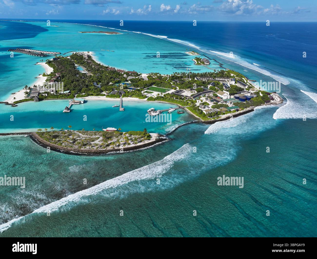 Aerial view of the resort's turquoise lagoon gently embrace the white ...