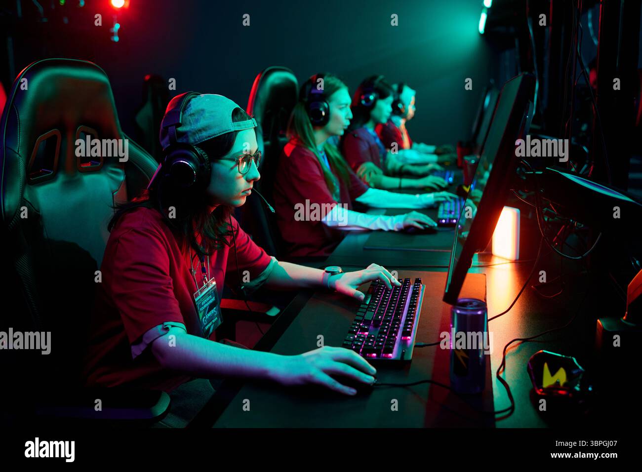 Group of multiethnic teenage girls wearing headsets competing in ...