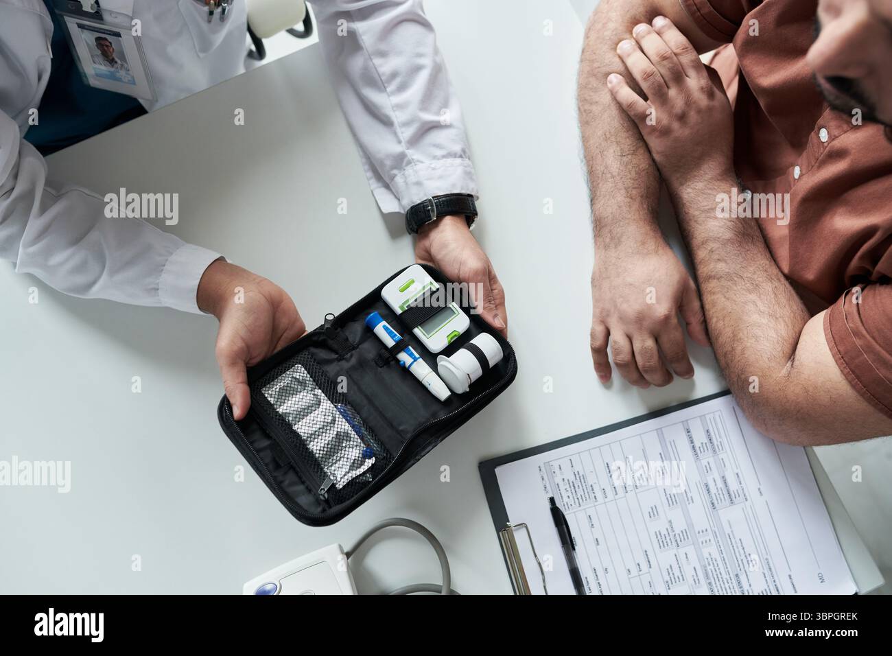 Middle aged Caucasian man sitting at desk with arms crossed while ...