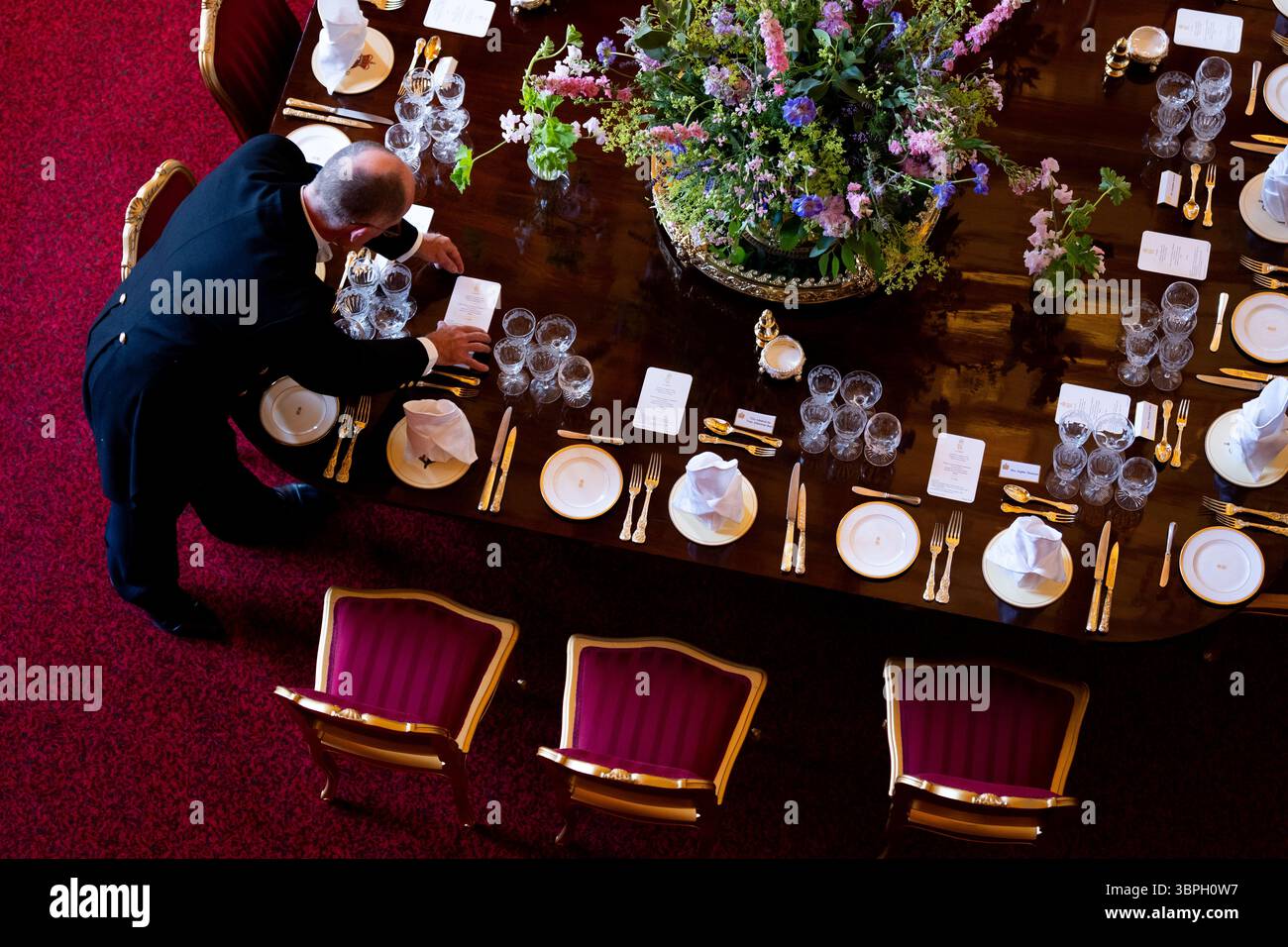 Adjustments are made to table decorations for the State Banquet for ...