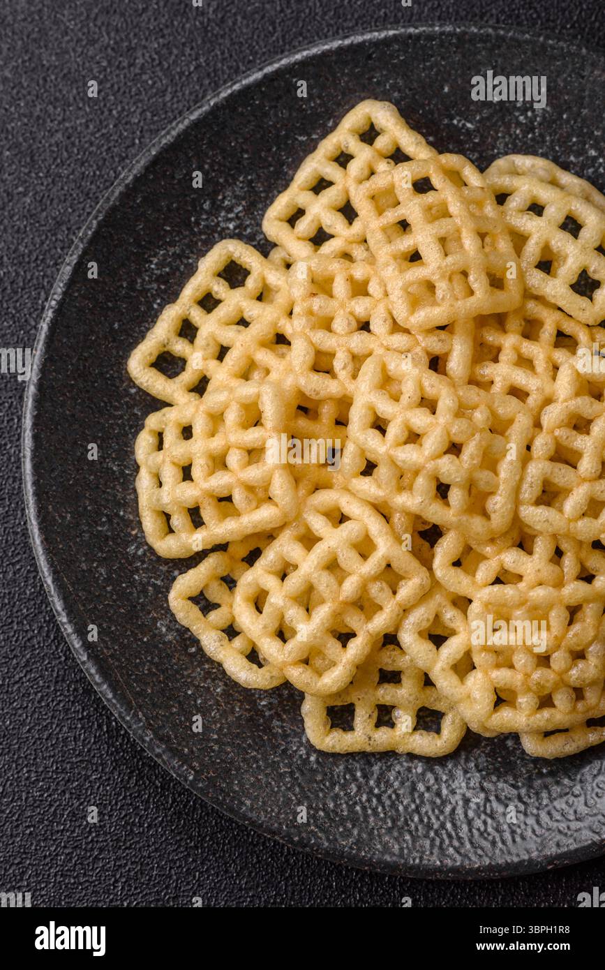 Lattice or wafer potato chips, crispy yellow snacks, takeaway food ...