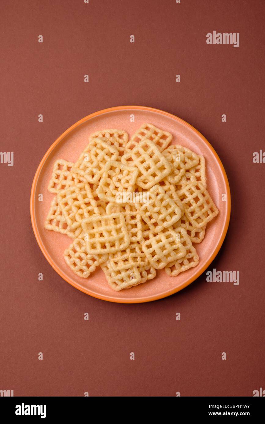 Lattice or wafer potato chips, crispy yellow snacks, takeaway food ...