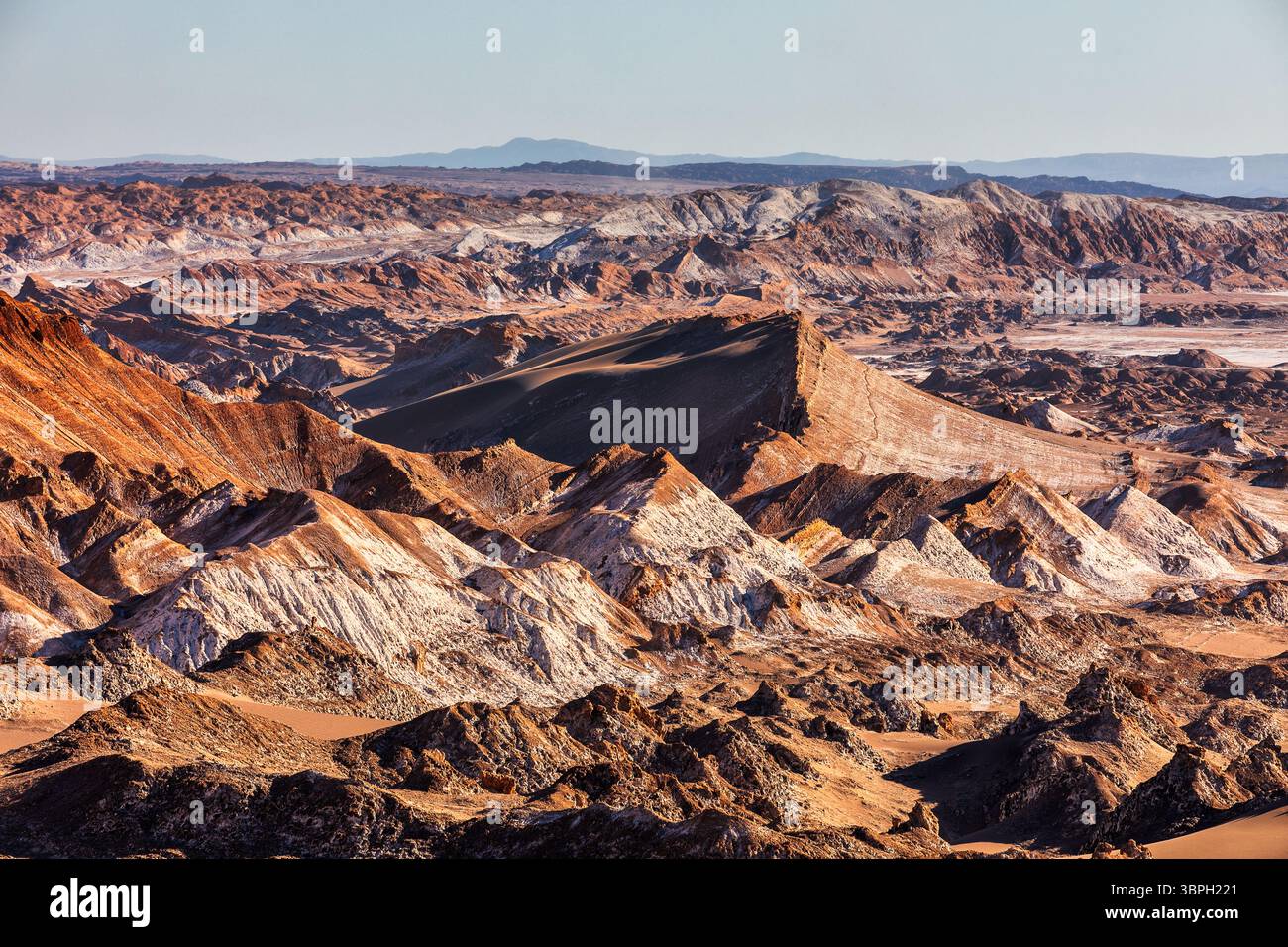 View of the rugged, sun-scorched terrain, where ochre-hued mountains ...