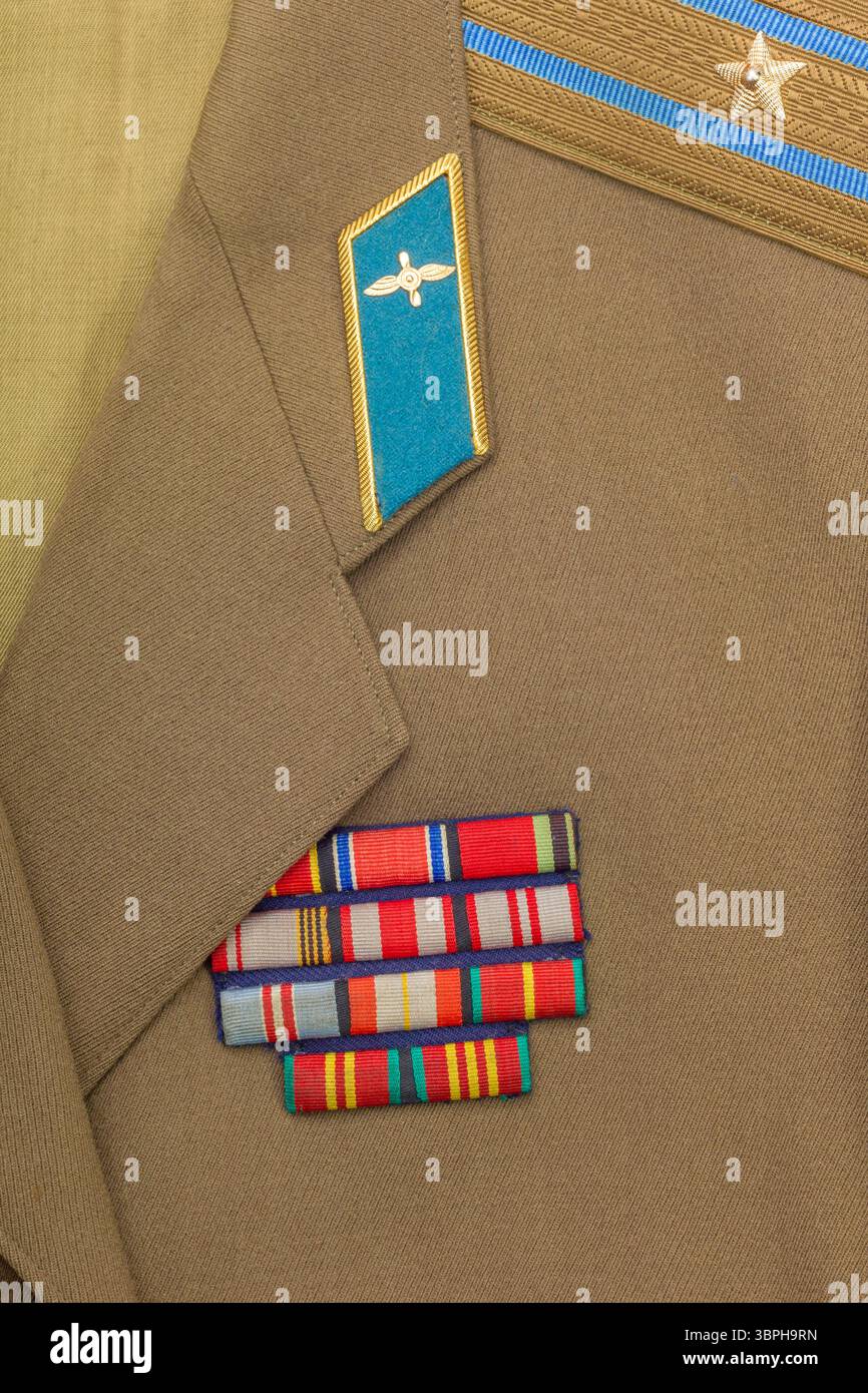 Military awards and epaulettes decorations on green uniform, top view ...
