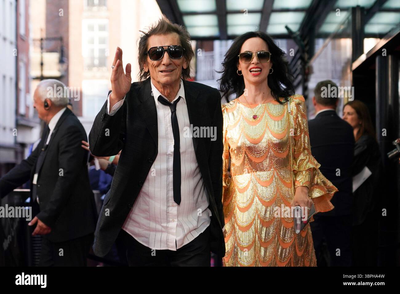 Ronnie Wood, left, and Sally Wood pose for photographers upon arrival ...